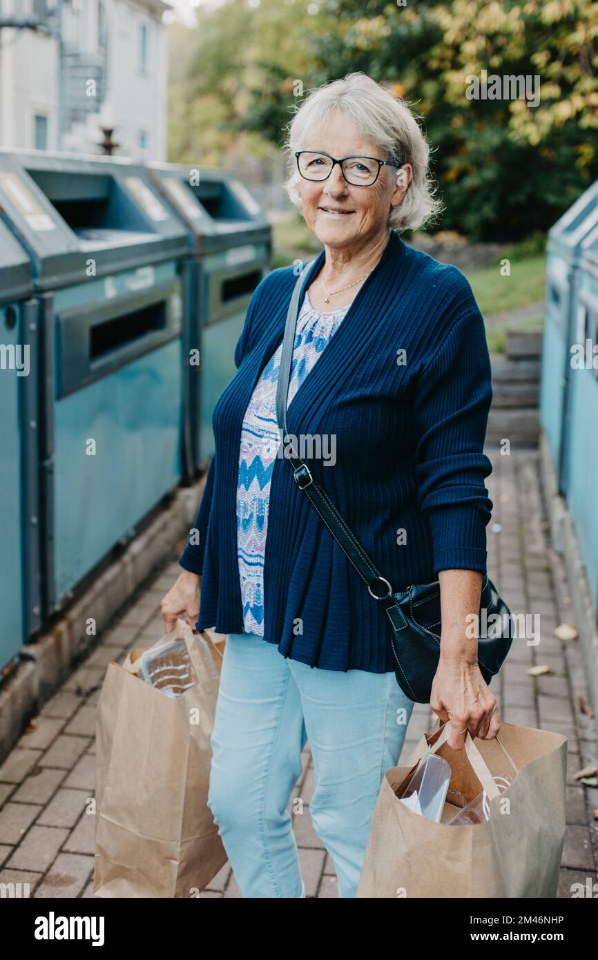 Mature woman rubbish bin hi-res stock photography and images - Alamy