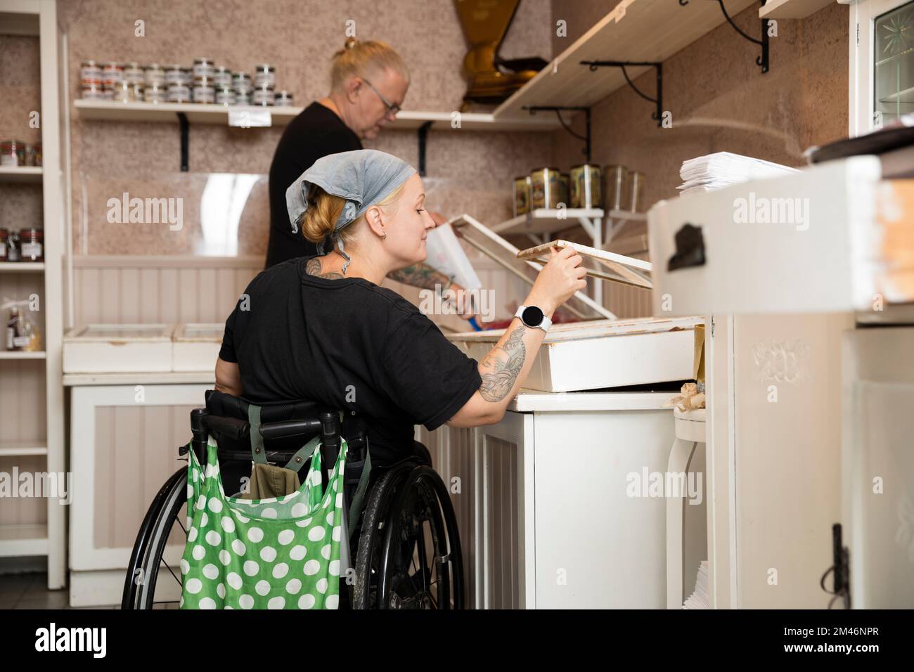 Disabled woman working in food factory Stock Photo - Alamy
