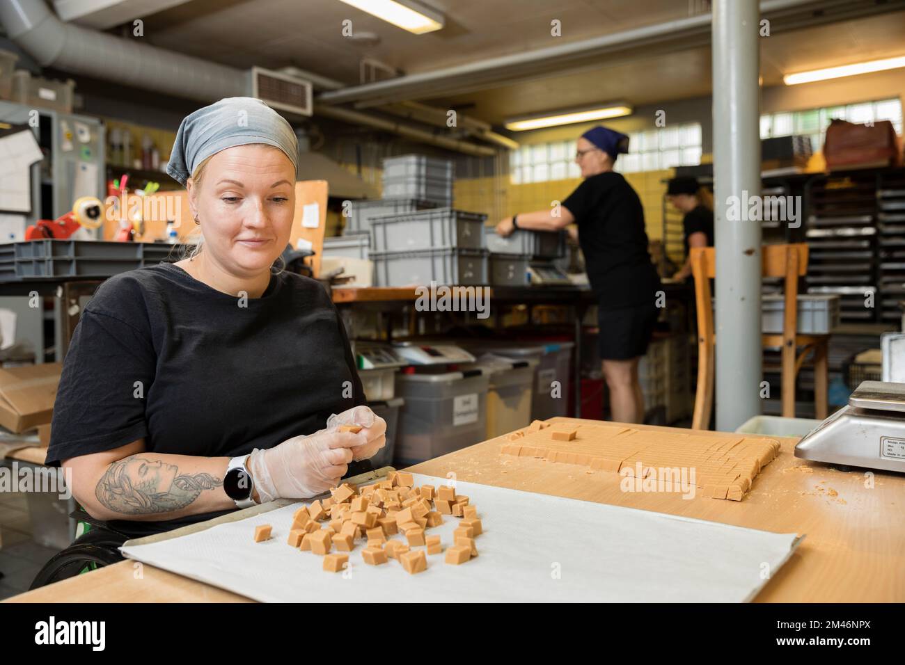 Disabled woman working in food factory Stock Photo - Alamy
