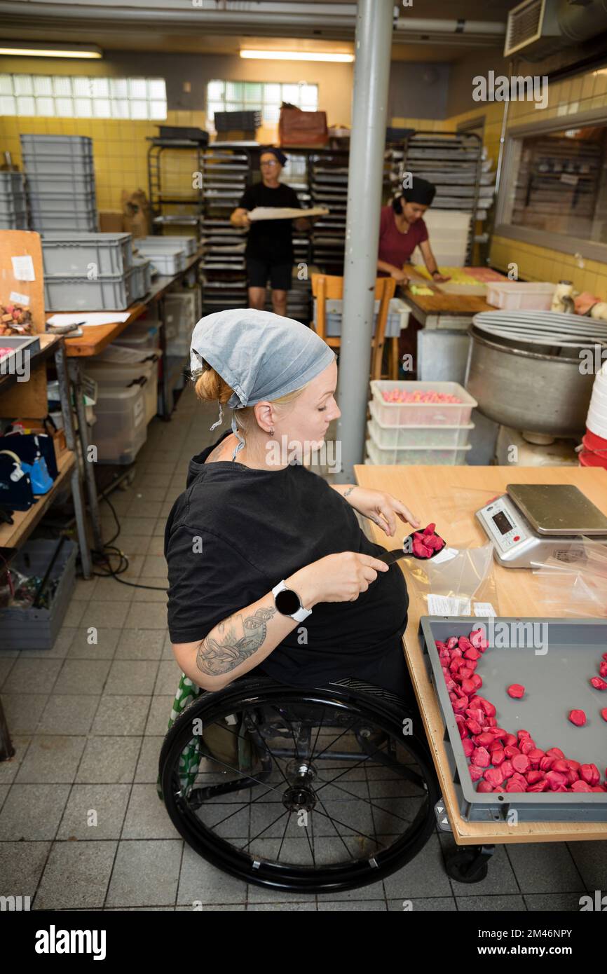 Disabled woman working in food factory Stock Photo - Alamy