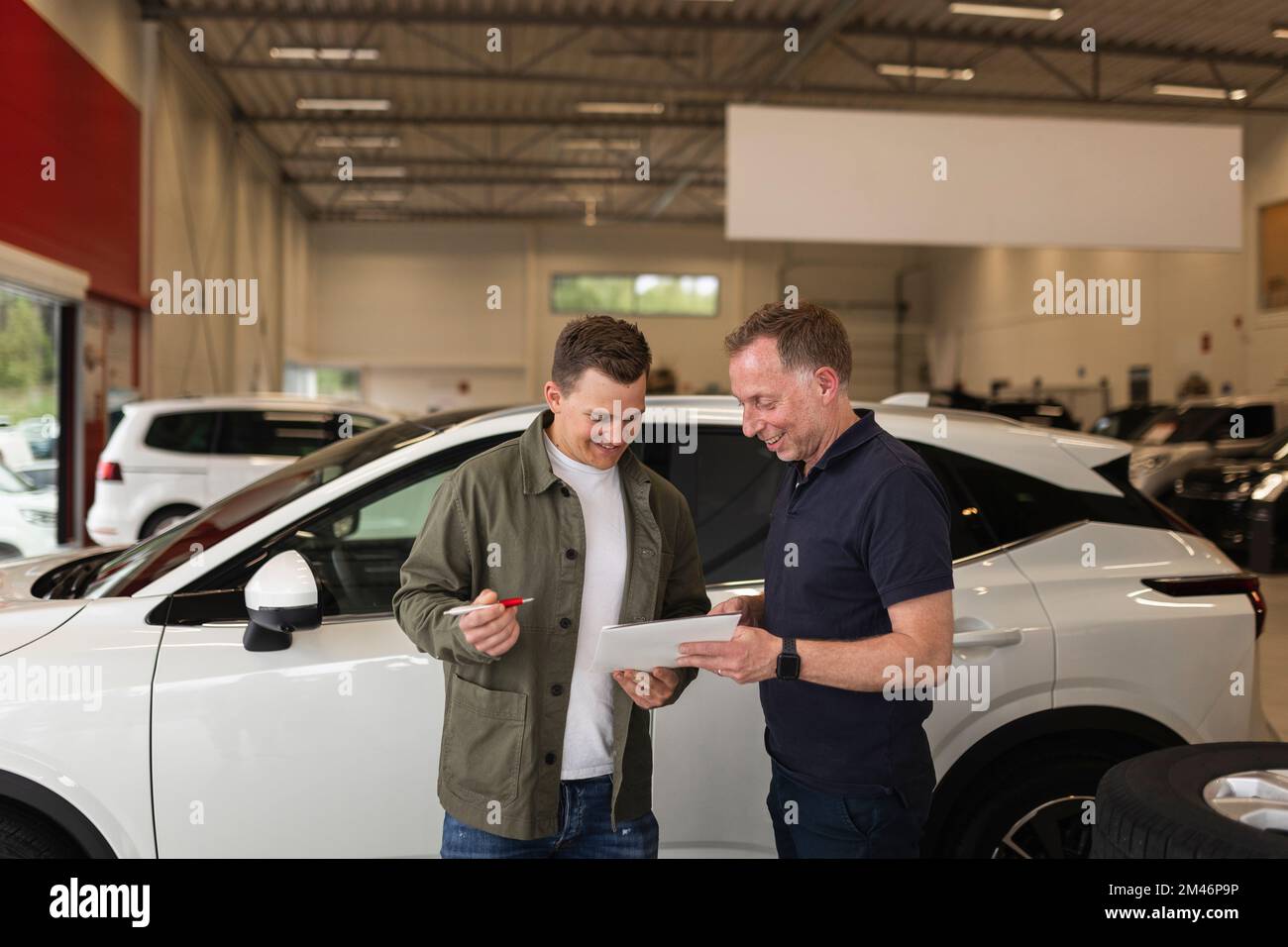 Man in car dealership office Stock Photo - Alamy