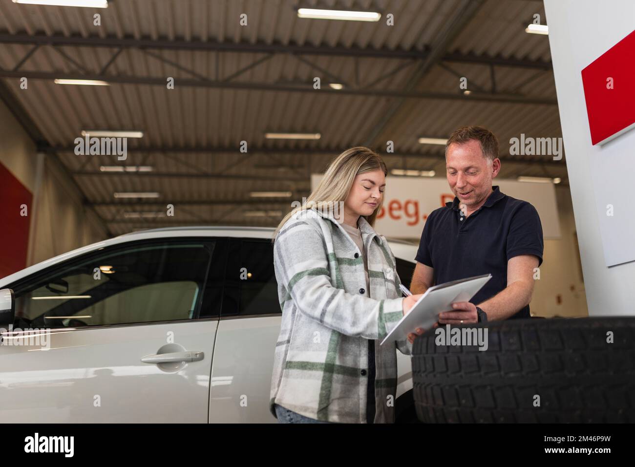 Woman in car dealership office Stock Photo - Alamy