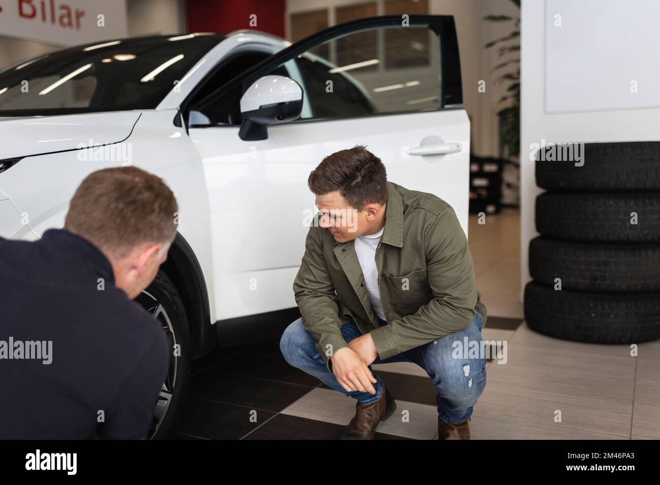 Men in car dealership office Stock Photo - Alamy