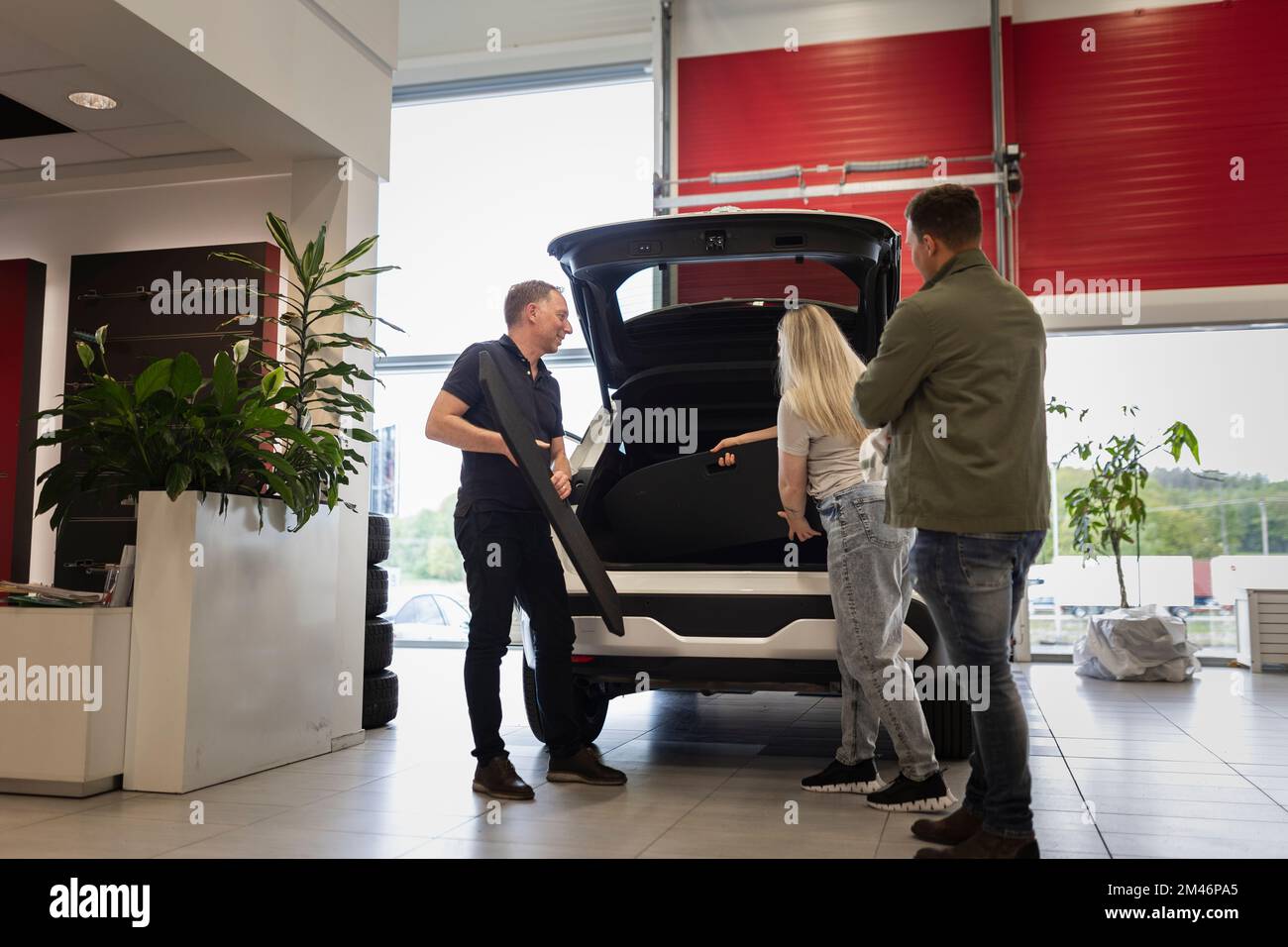 Customers in car dealership office Stock Photo - Alamy