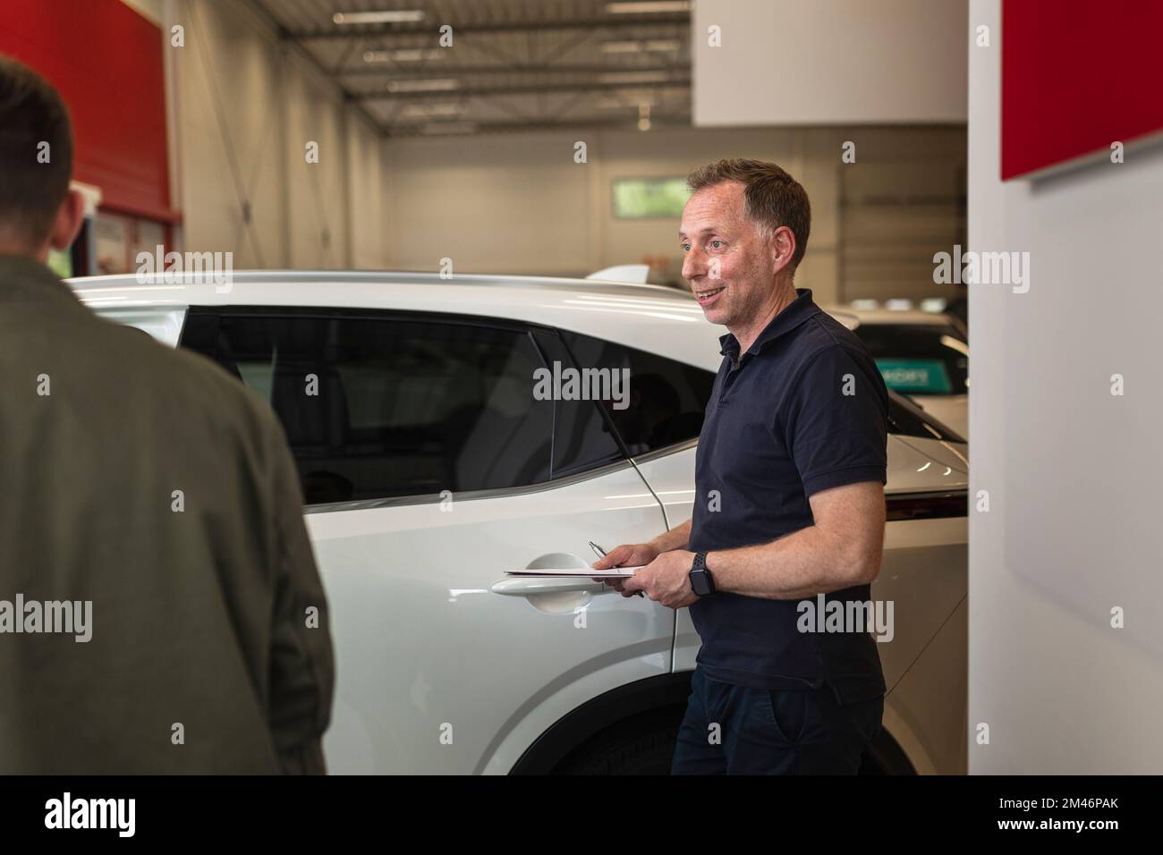 Men in car dealership office Stock Photo - Alamy