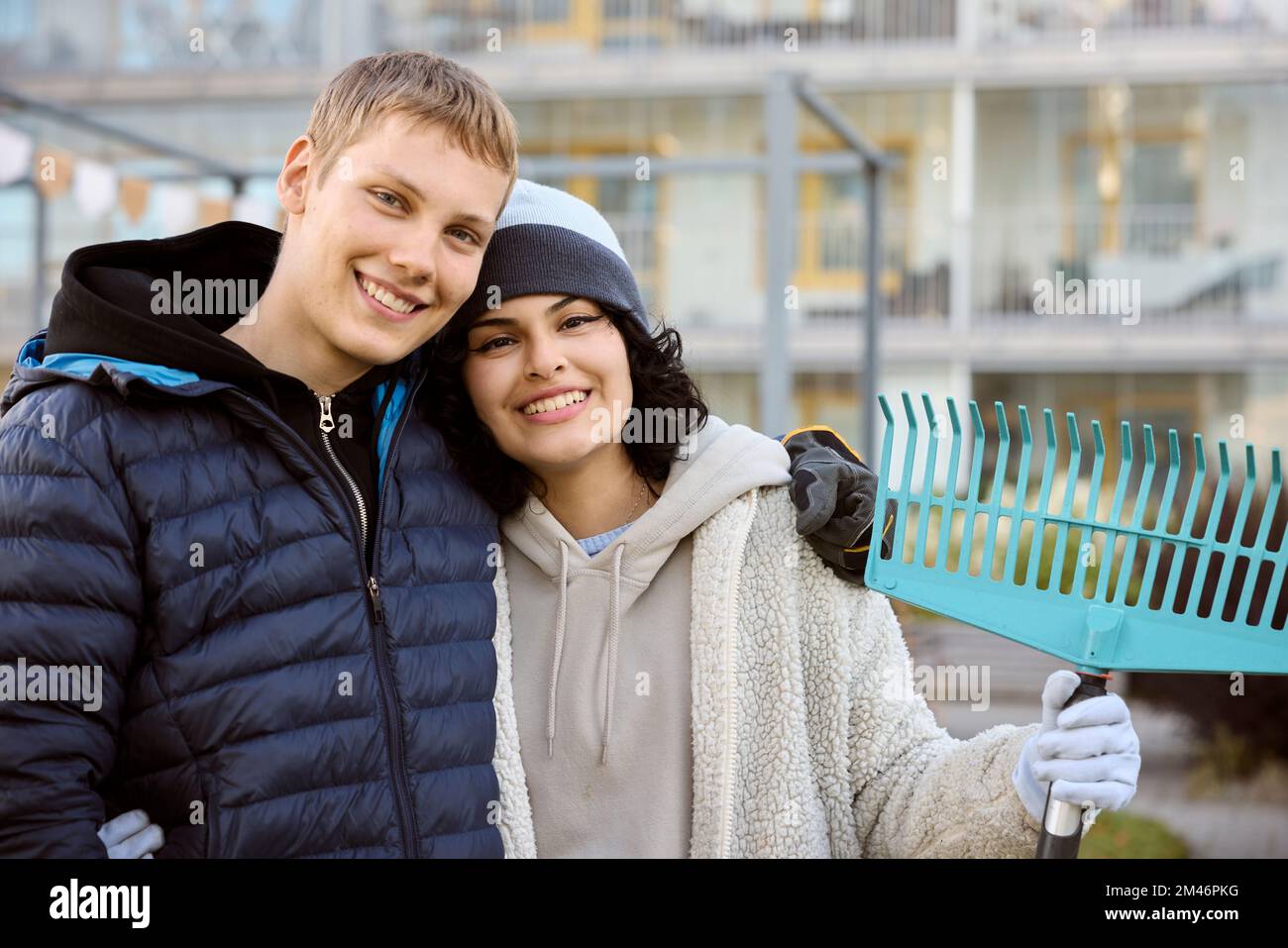 Young people holding garden tools Stock Photo - Alamy