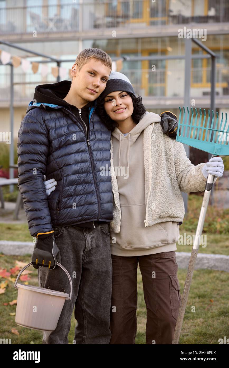 Young people holding garden tools Stock Photo - Alamy