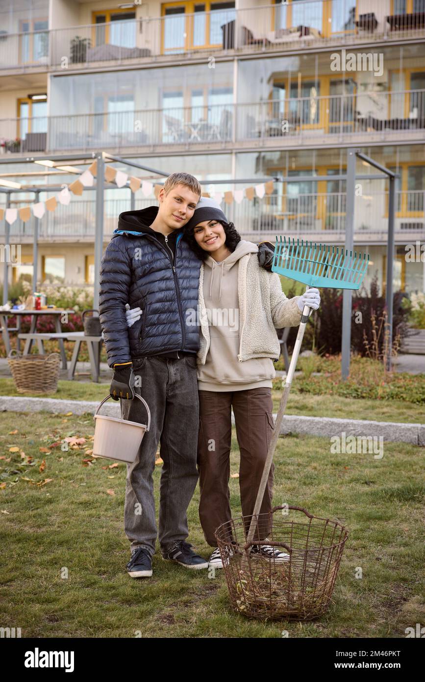 Young people holding garden tools Stock Photo - Alamy