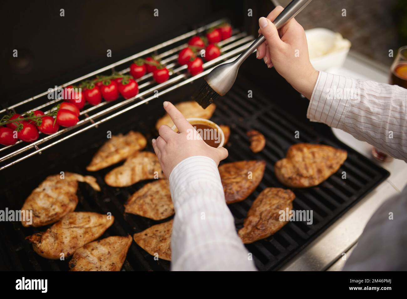 Putting marinade on meat Stock Photo - Alamy