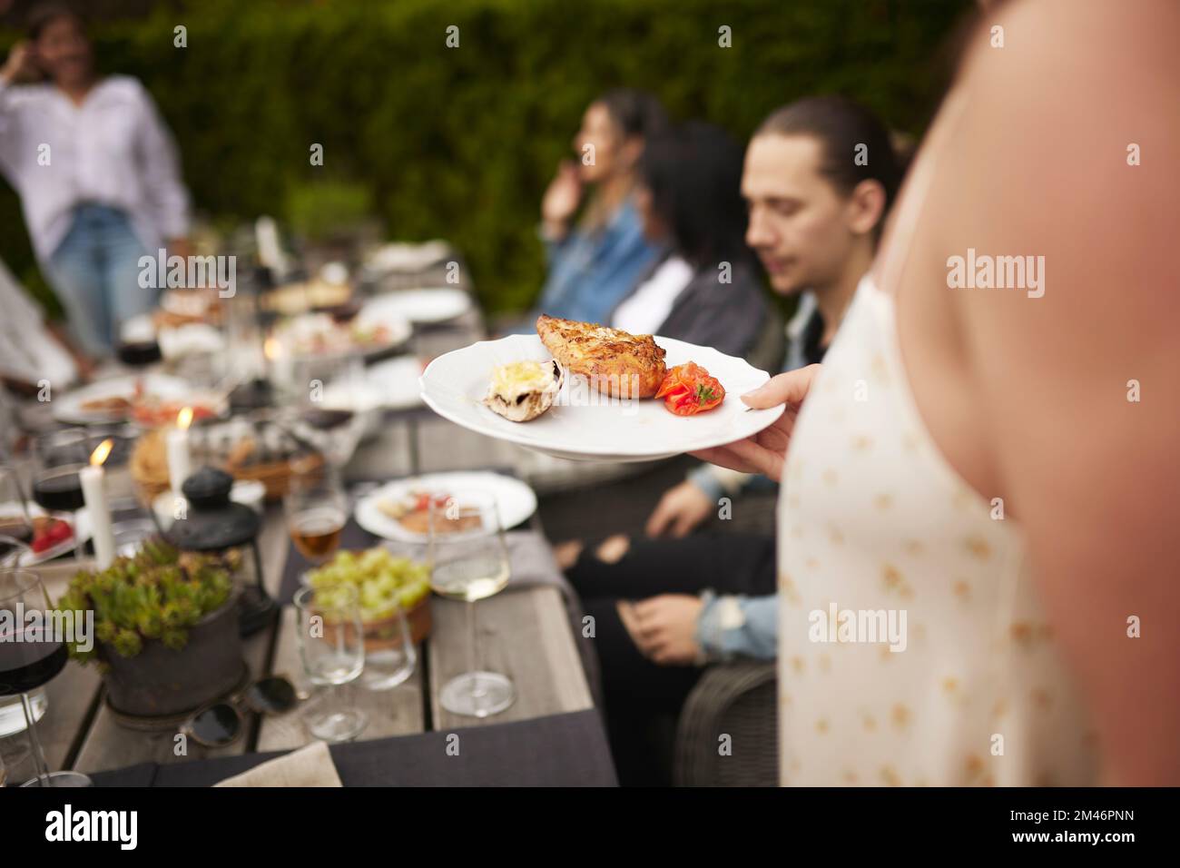 Person holding food on plate Stock Photo - Alamy
