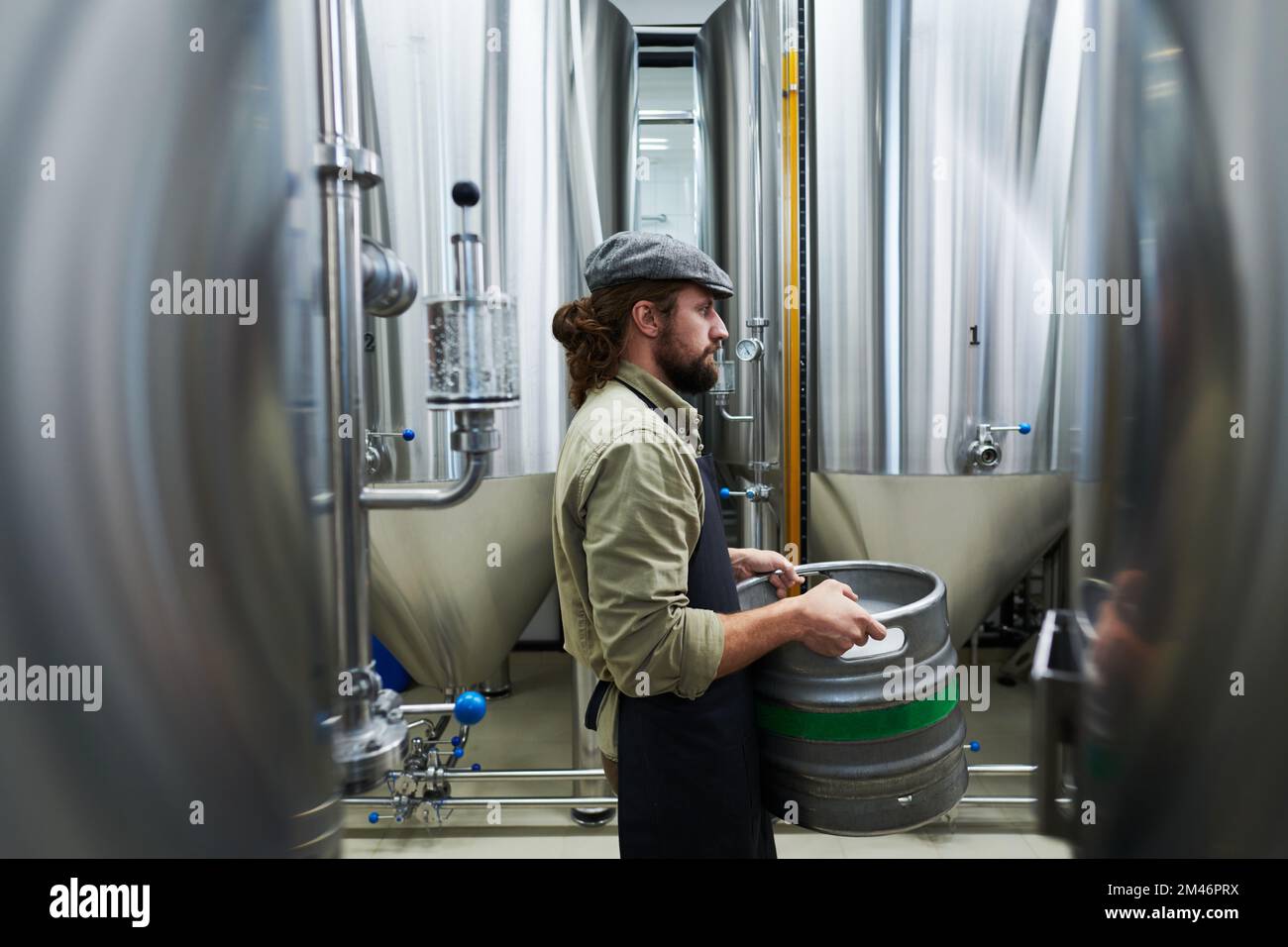 Side view of private brewery worker carrying keg of beer Stock Photo ...