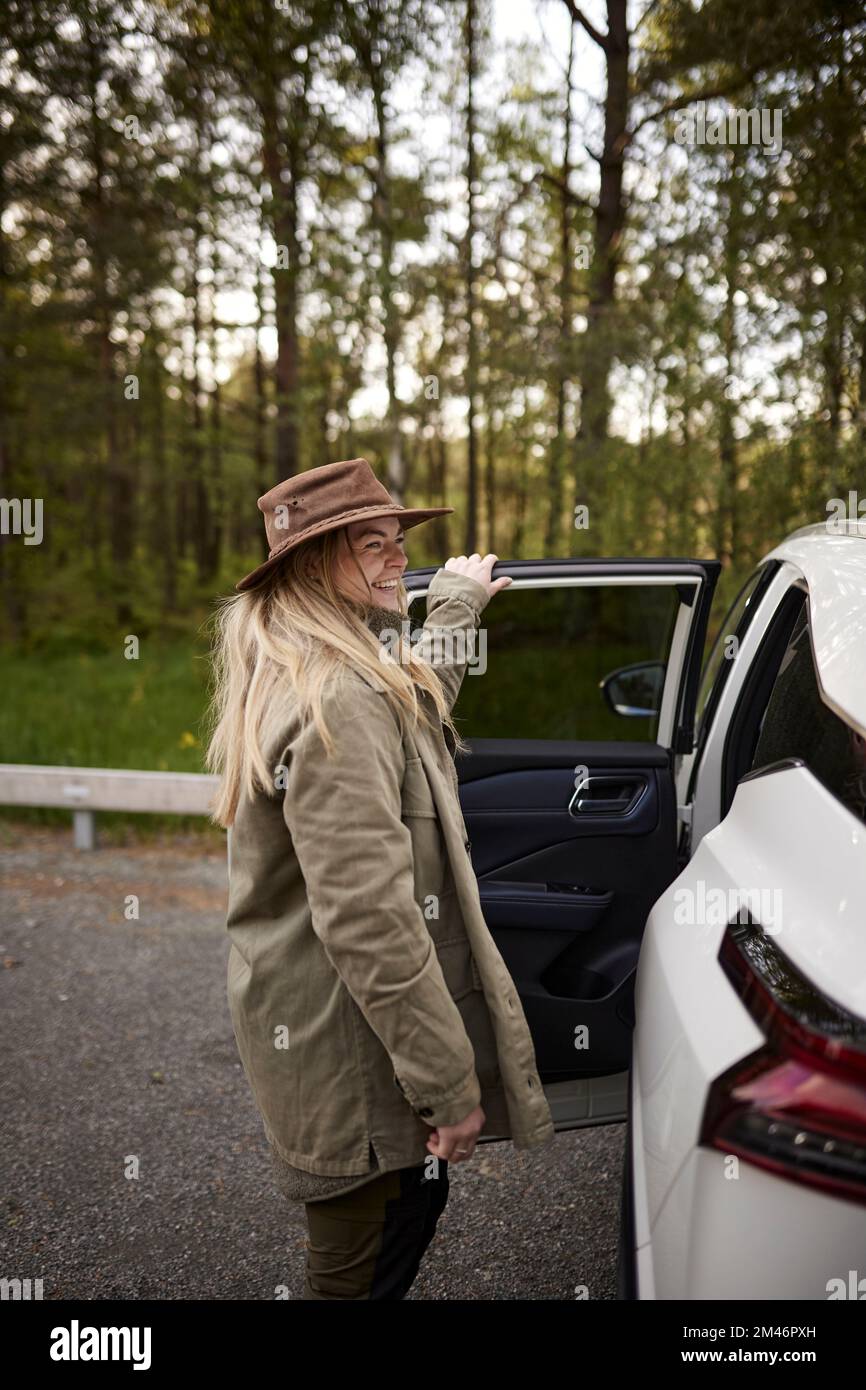 Mature woman standing near car hi-res stock photography and images - Alamy