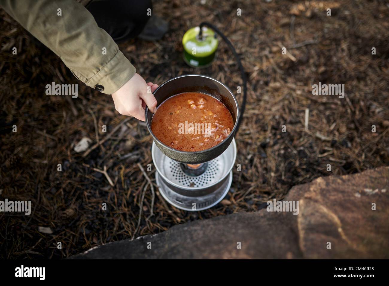 Heating food on camping stove Stock Photo - Alamy