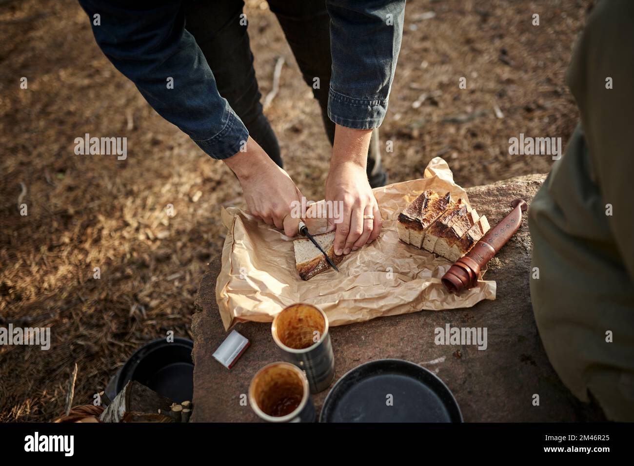 Hands cutting bread Stock Photo - Alamy