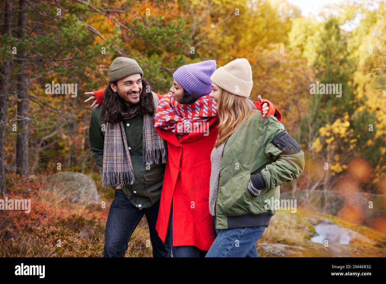 Smiling friends standing together Stock Photo - Alamy