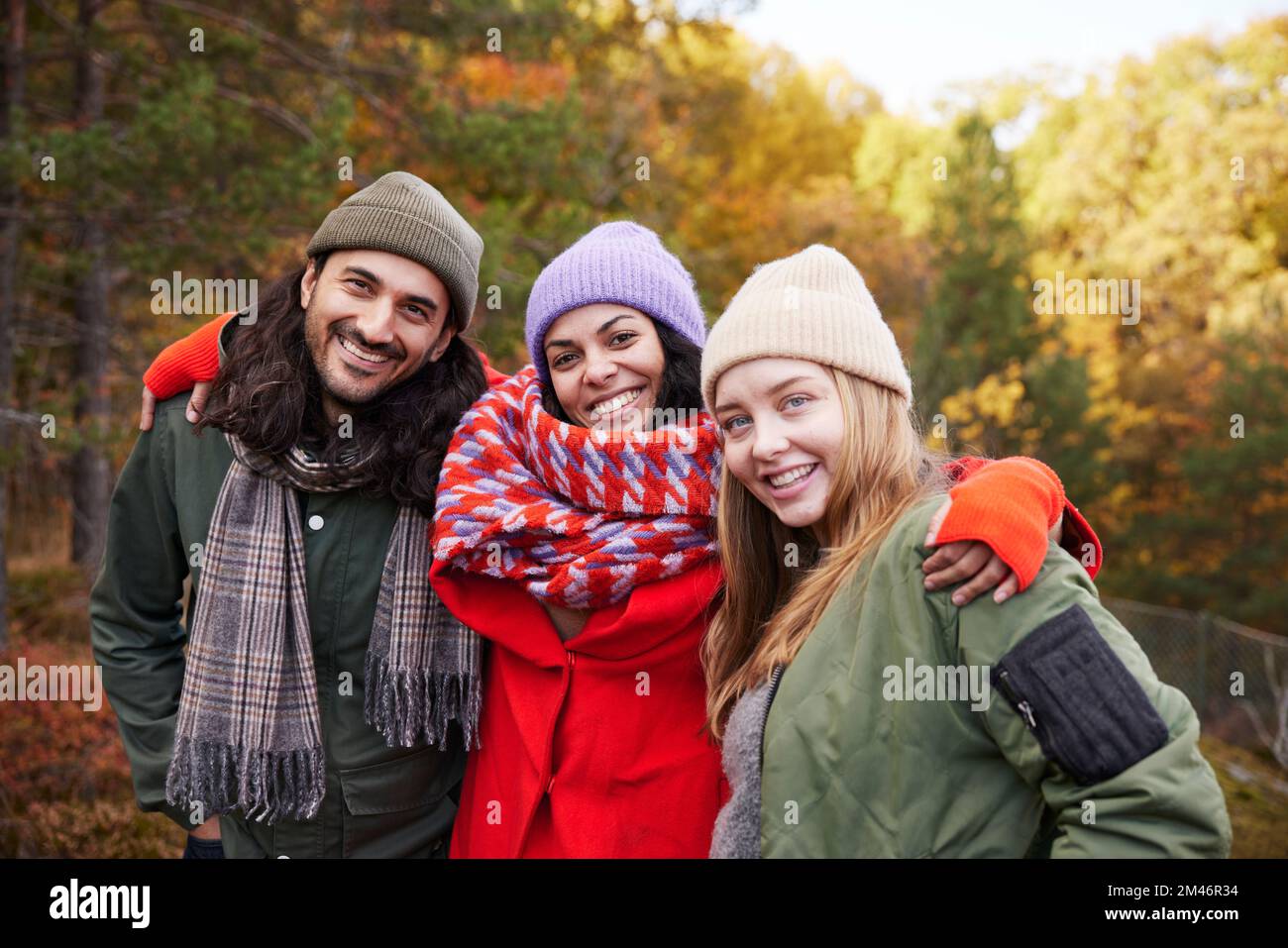 Smiling friends looking at camera Stock Photo - Alamy