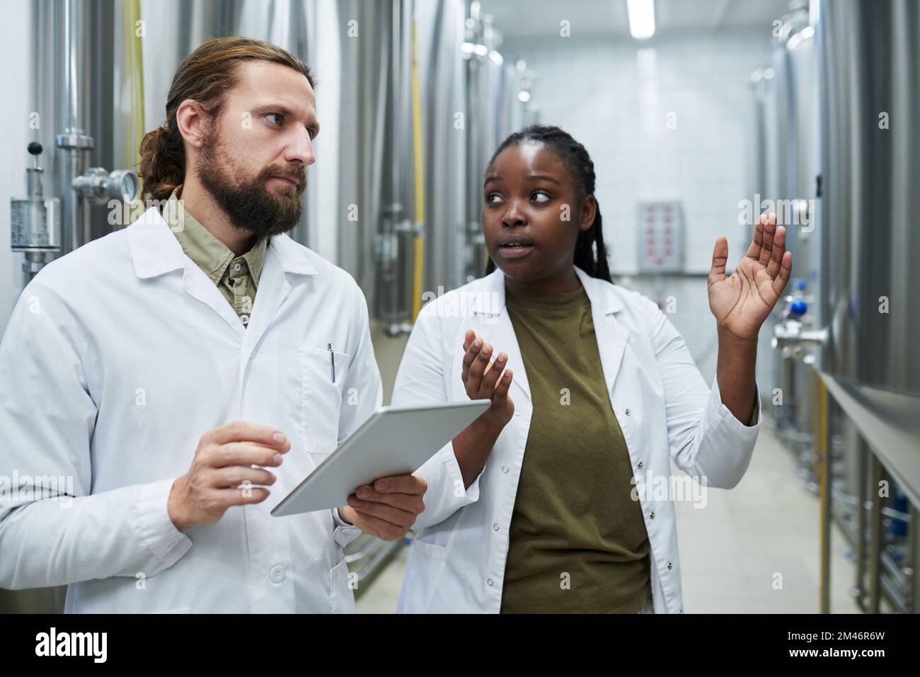 Team of inspectors checking equipment in microbrewery Stock Photo - Alamy