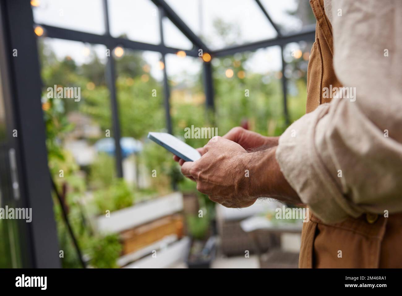 Mid section of man holding cell phone Stock Photo - Alamy