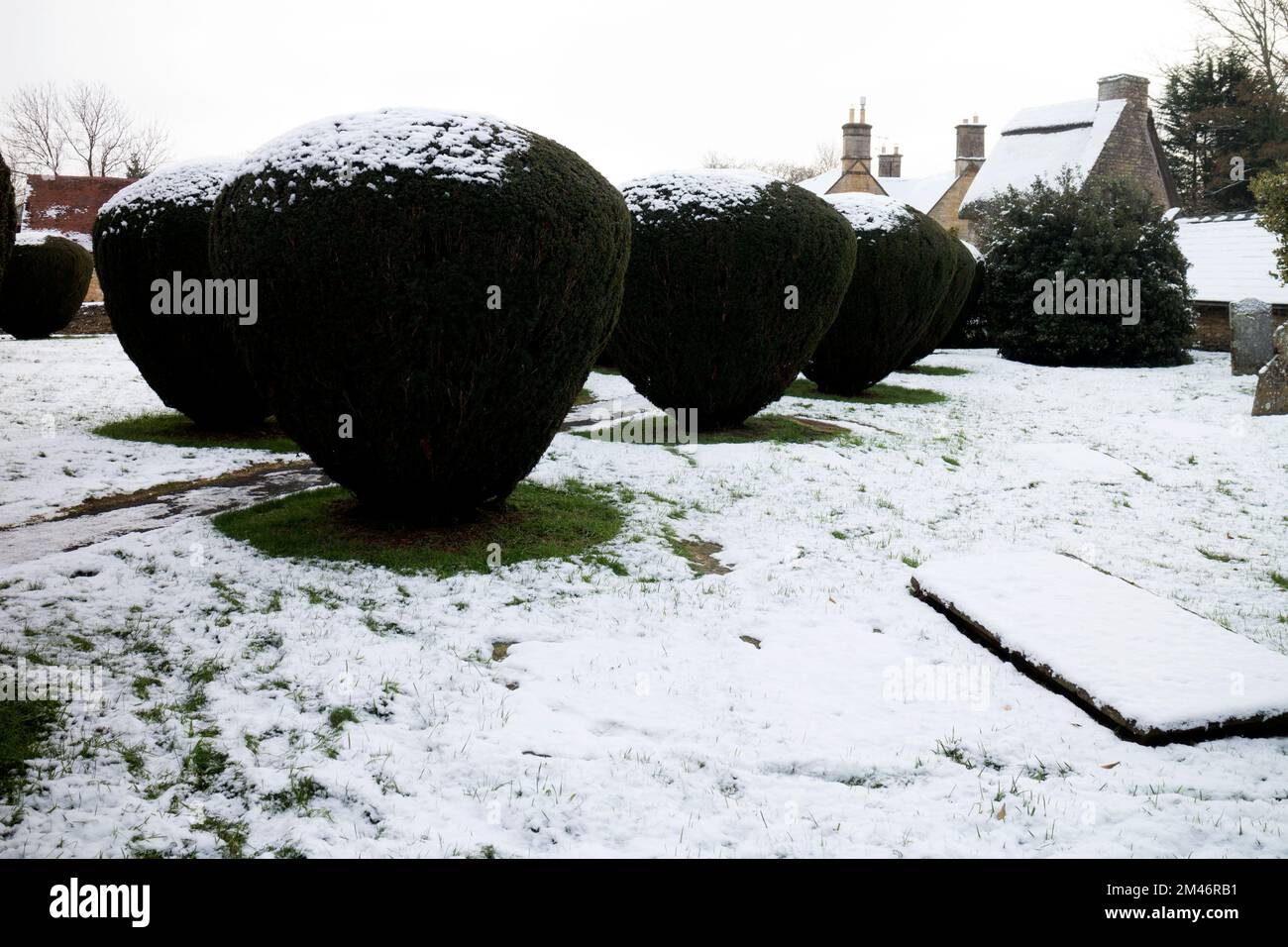 St Peter and St Paul churchyard in winter, Long Compton, Warwickshire ...