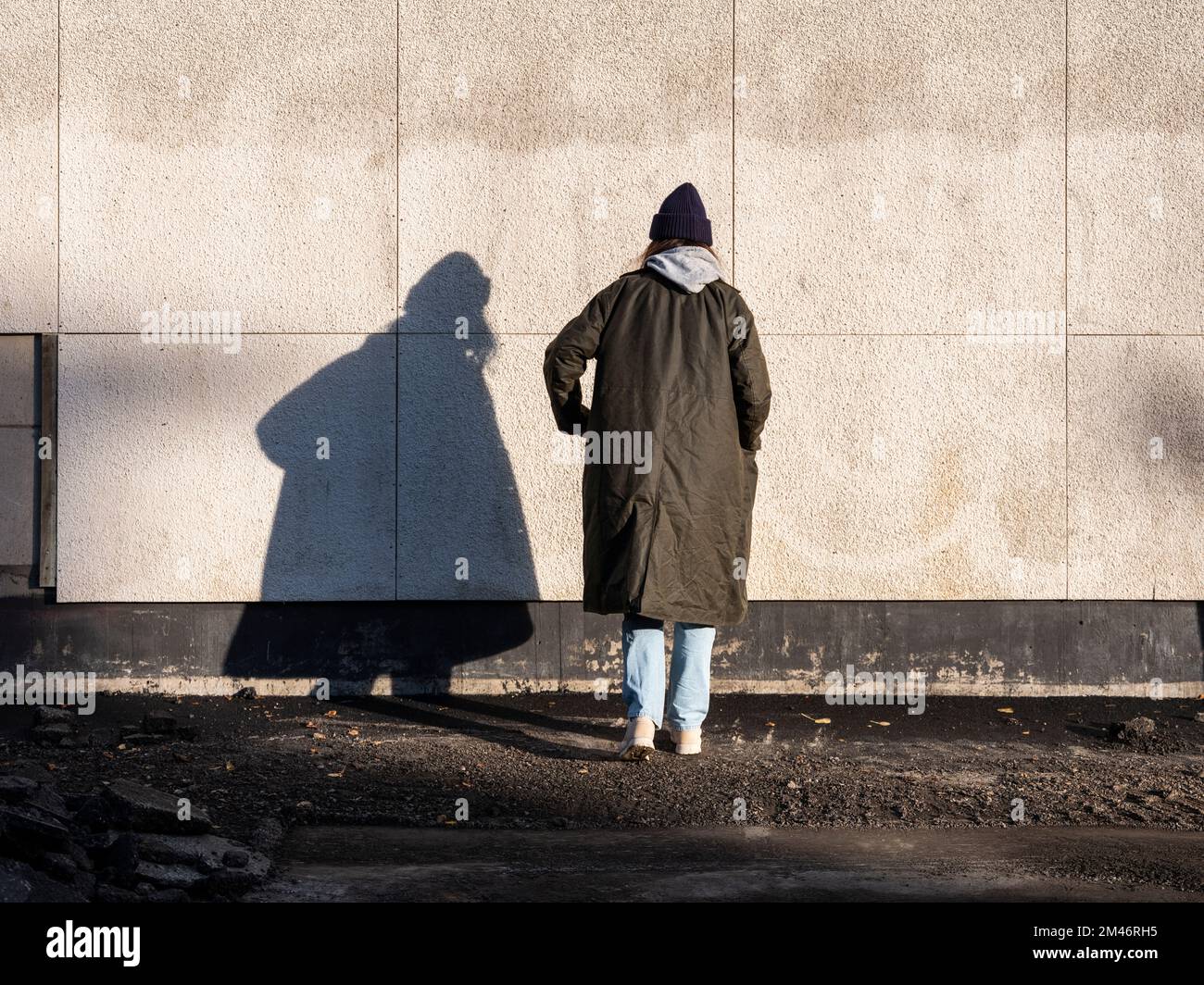Woman and her shadow on wall Stock Photo - Alamy