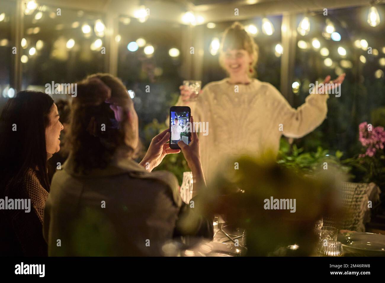 Friends having evening meal together Stock Photo - Alamy