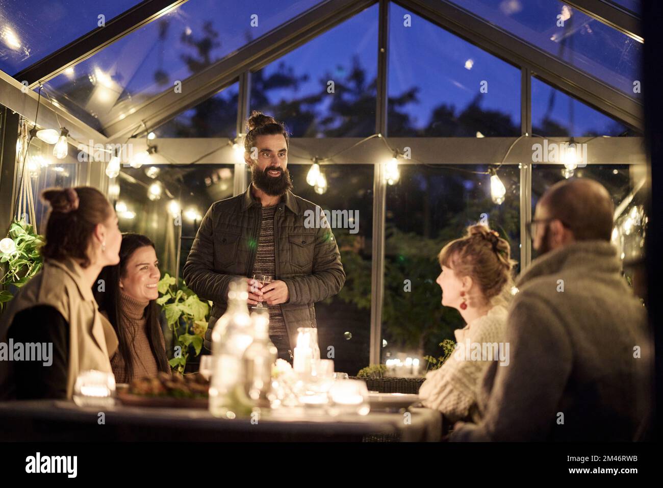 Friends having evening meal together Stock Photo - Alamy