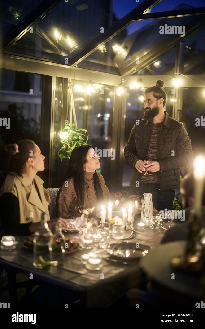 Happy friends having evening meal together Stock Photo - Alamy