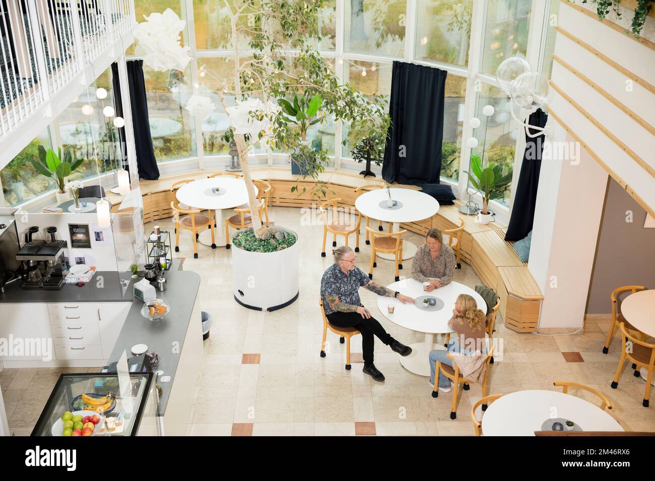 Teacher with students talking in cafeteria Stock Photo - Alamy