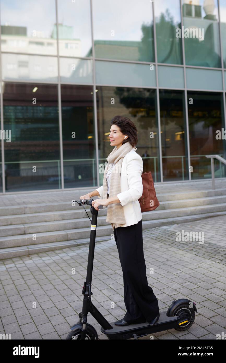 Lady riding scooter hi-res stock photography and images - Alamy