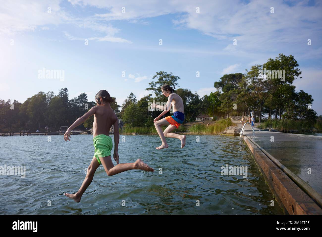 Boys jumping into water hi-res stock photography and images - Alamy