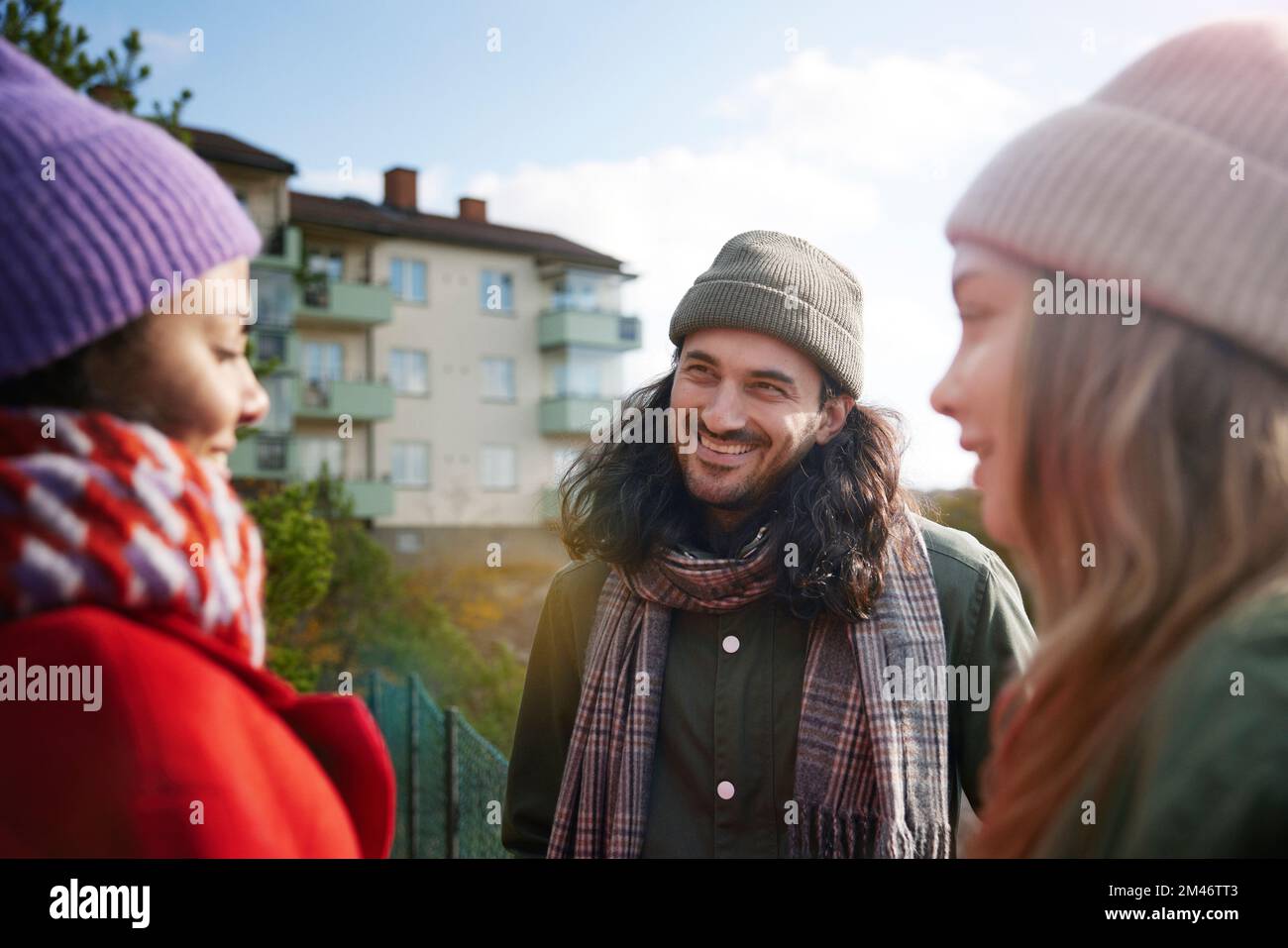 Smiling friends talking together Stock Photo - Alamy
