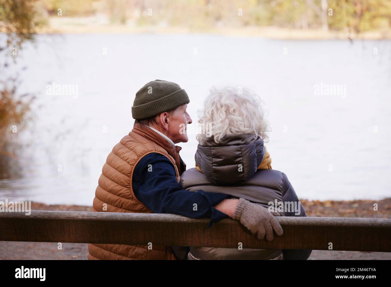 Senior couple resting at lakeside Stock Photo - Alamy