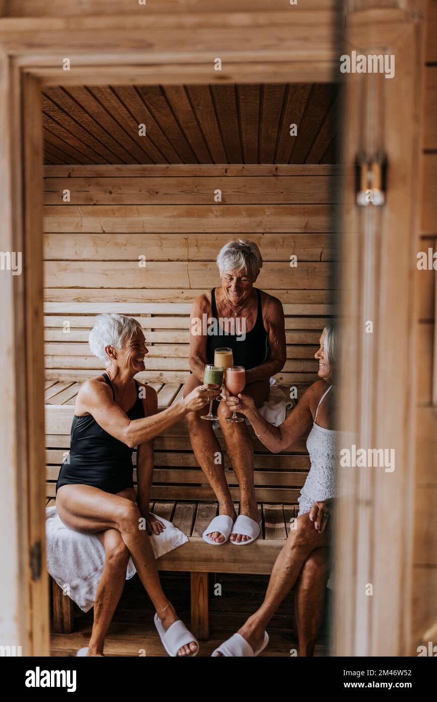 Happy female friends in sauna Stock Photo - Alamy