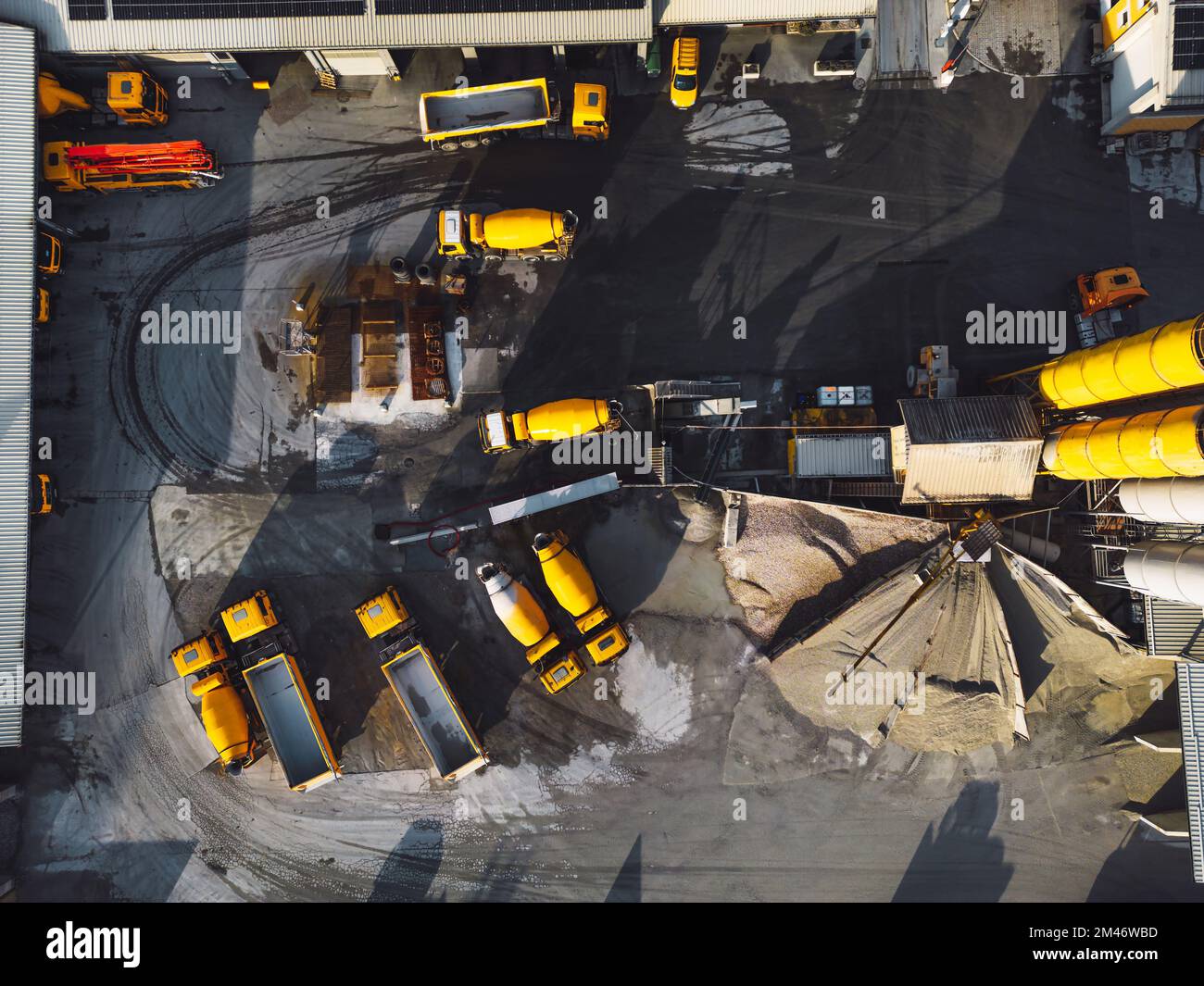 Top down view at a construction site company base with yellow heavy ...