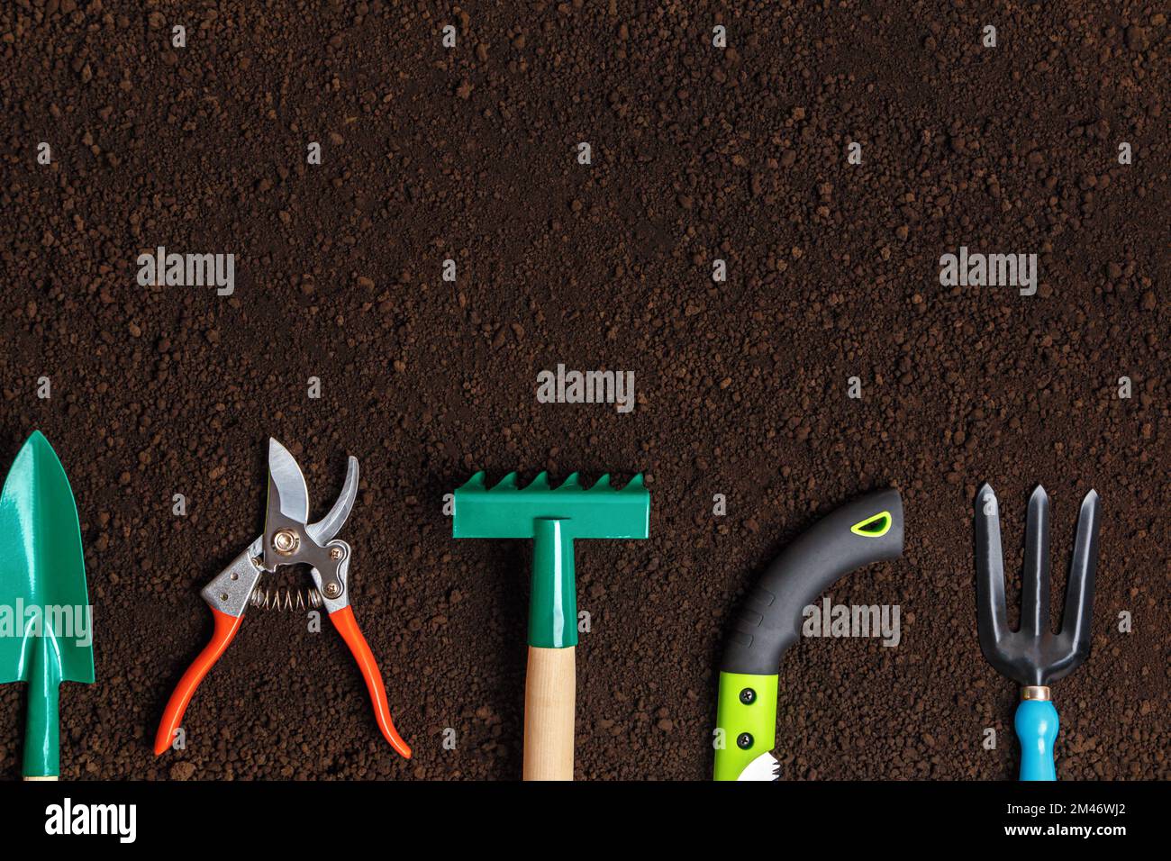 Garden tools for working on the ground. Shovel pruner rake hacksaw fork ...