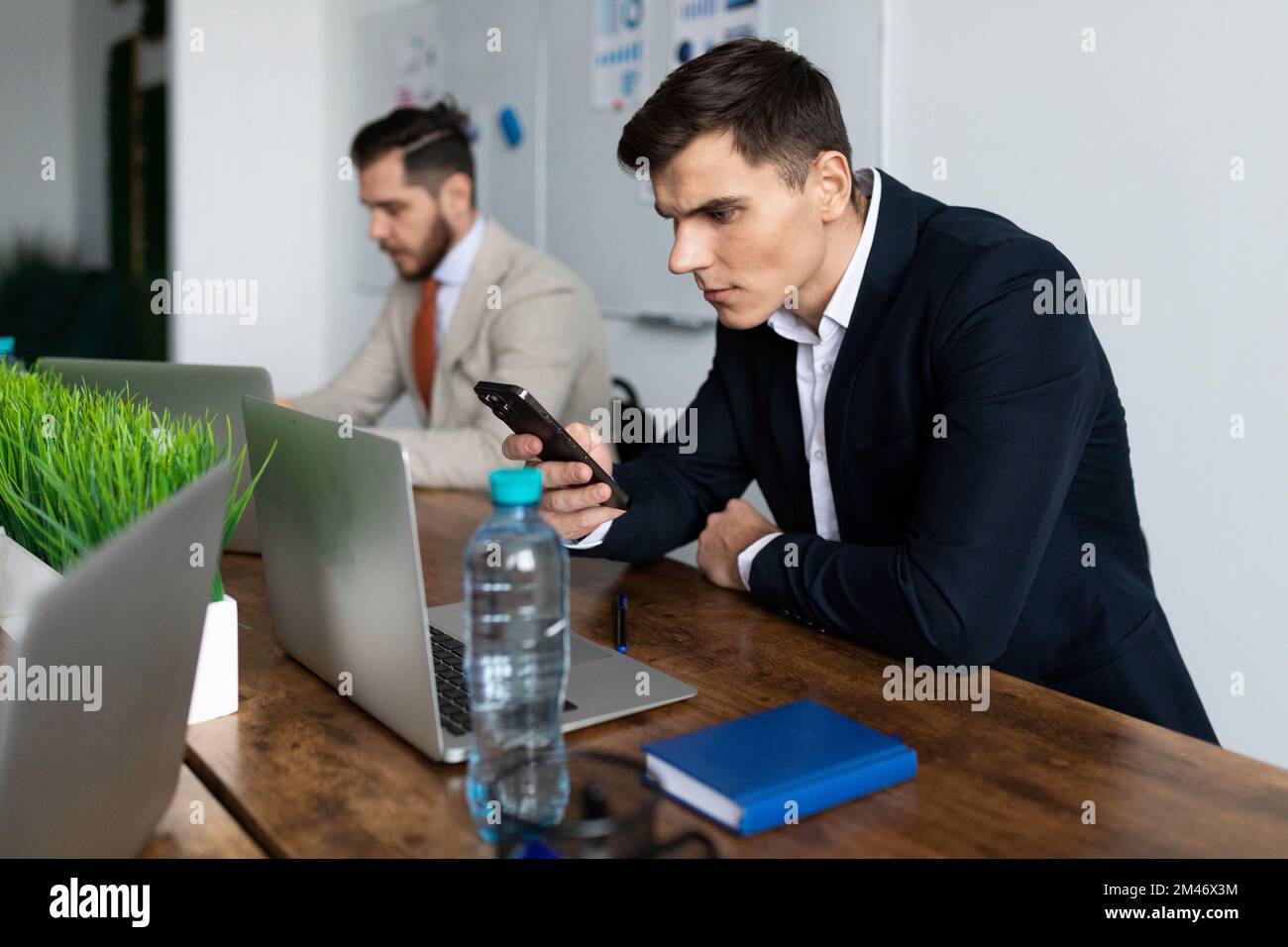office staff in a meeting with a mobile phone sitting at the table ...