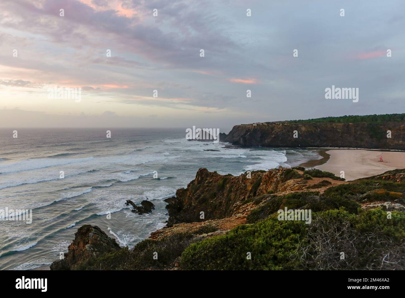 A beautiful shot of sea waves covering a sandy coastline under a cloudy ...