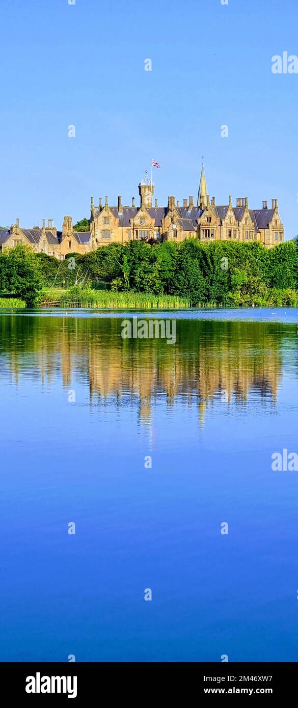 A vertical shot of calm water reflecting the Brownlow House Stock Photo ...