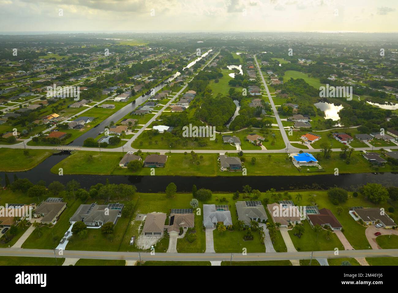 Aerial landscape view of suburban private houses between green palm ...