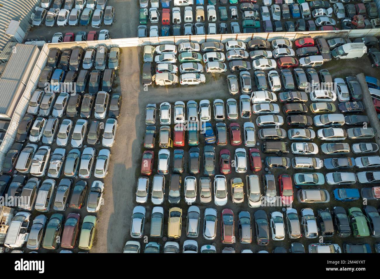Aerial view of big parking lot of junkyard with rows of discarded ...
