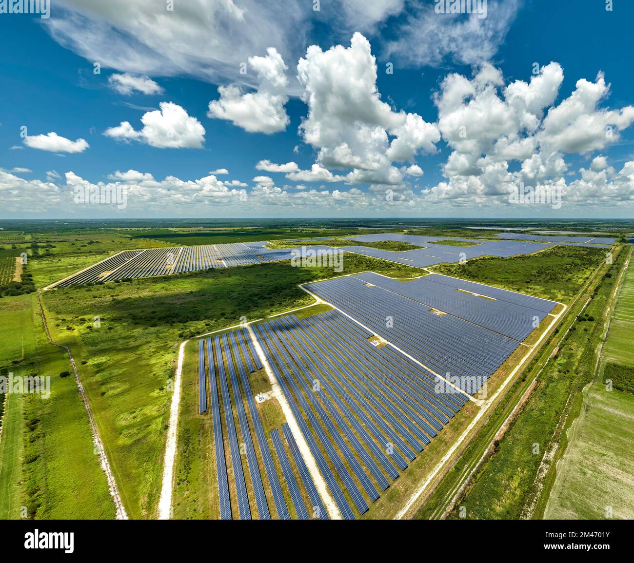 Aerial view of big sustainable electric power plant with many rows of ...