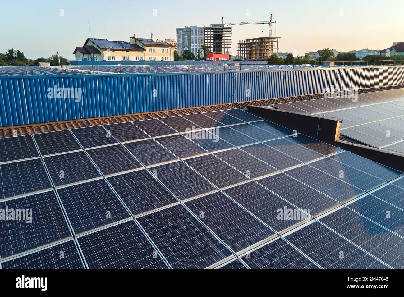 Aerial view of blue photovoltaic solar panels mounted on industrial ...