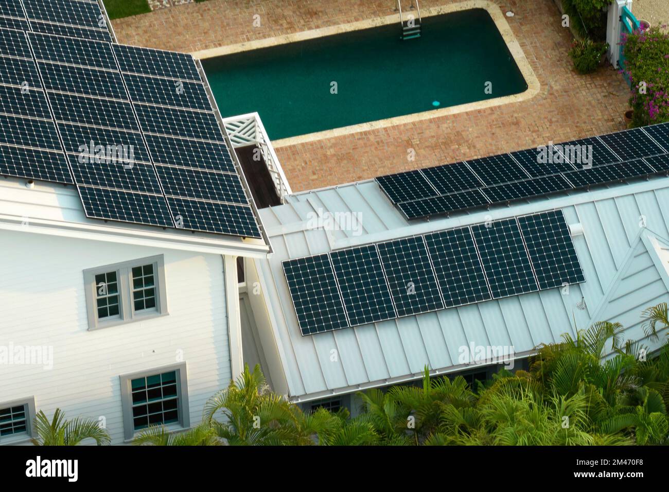 Aerial view of expensive american home roof with blue solar photovoltaic panels for producing ...