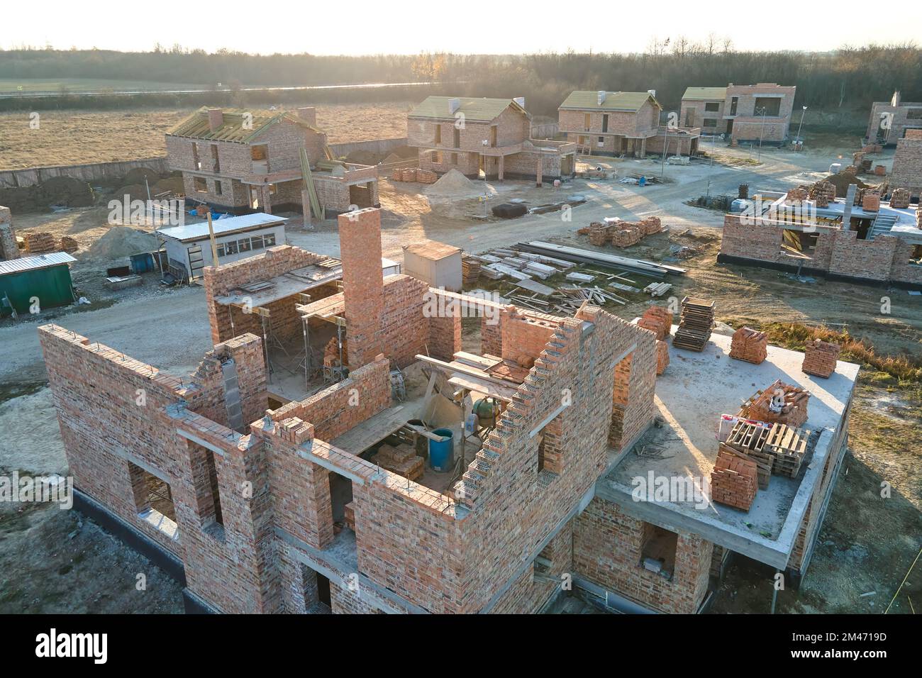 Aerial view of new homes with brick framework walls under construction ...