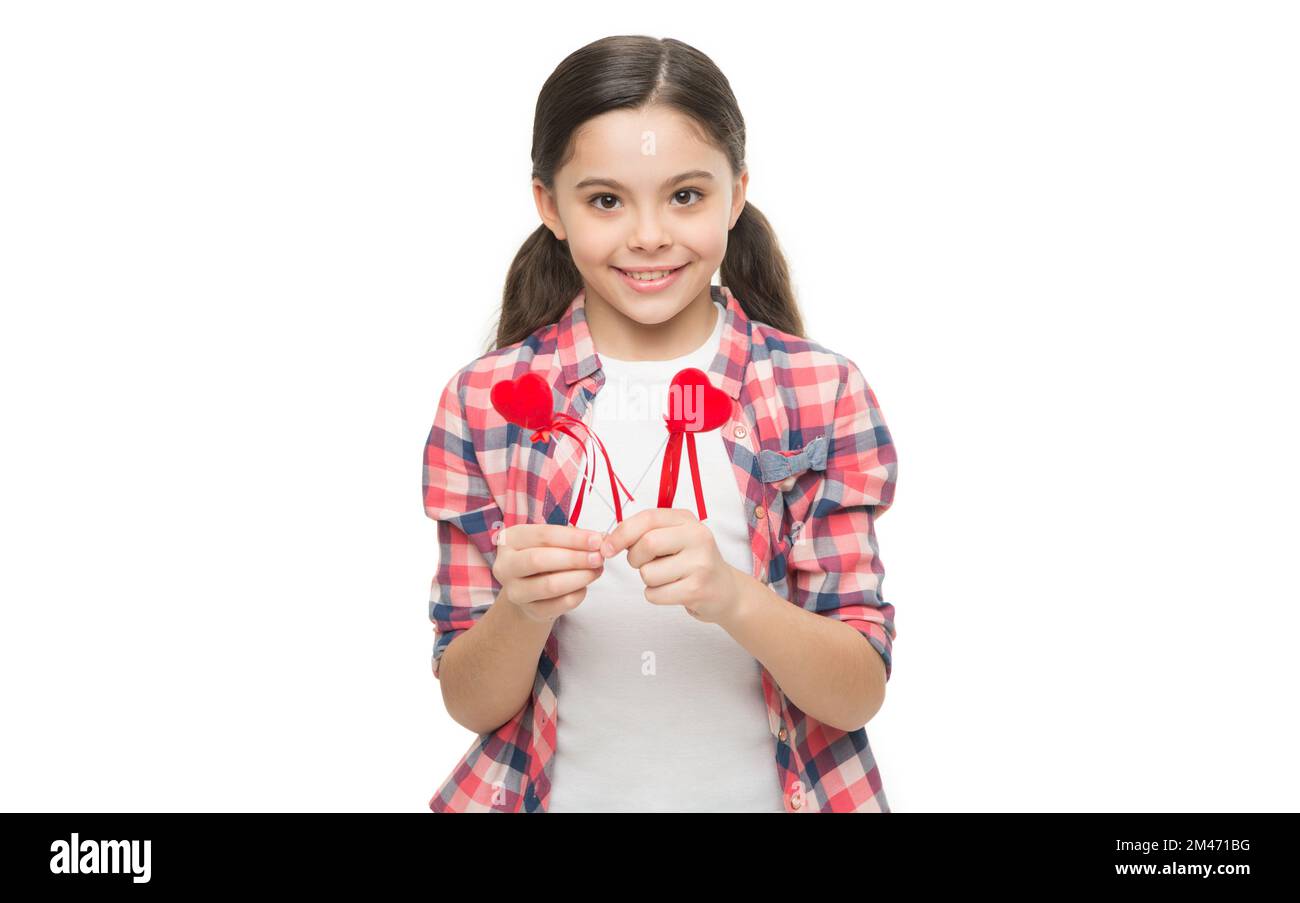 Small girl holding hearts on sticks. Cute girl with red hearts. Child ...