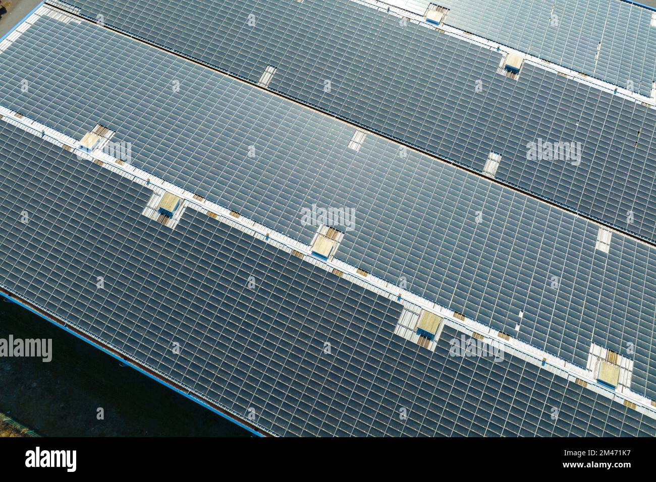 Aerial view of solar power plant with blue photovoltaic panels mounted ...