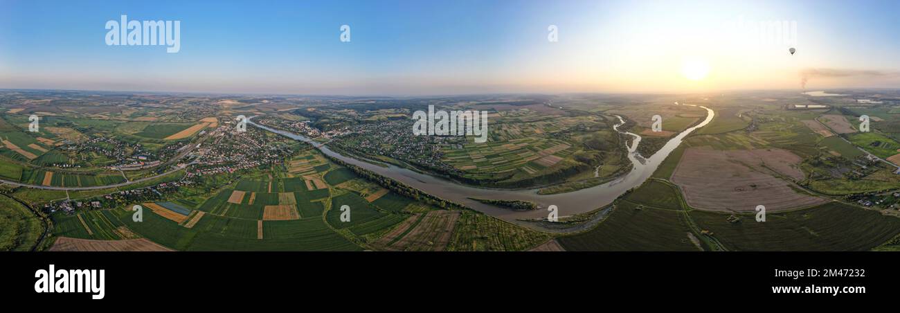 Aerial view of wide river flowing quietly in rural countryside between ...