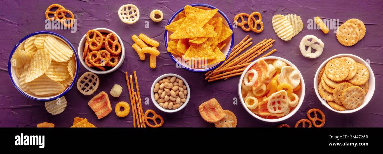 Salty snacks panorama. Party food mix. A table of assorted appetizers ...