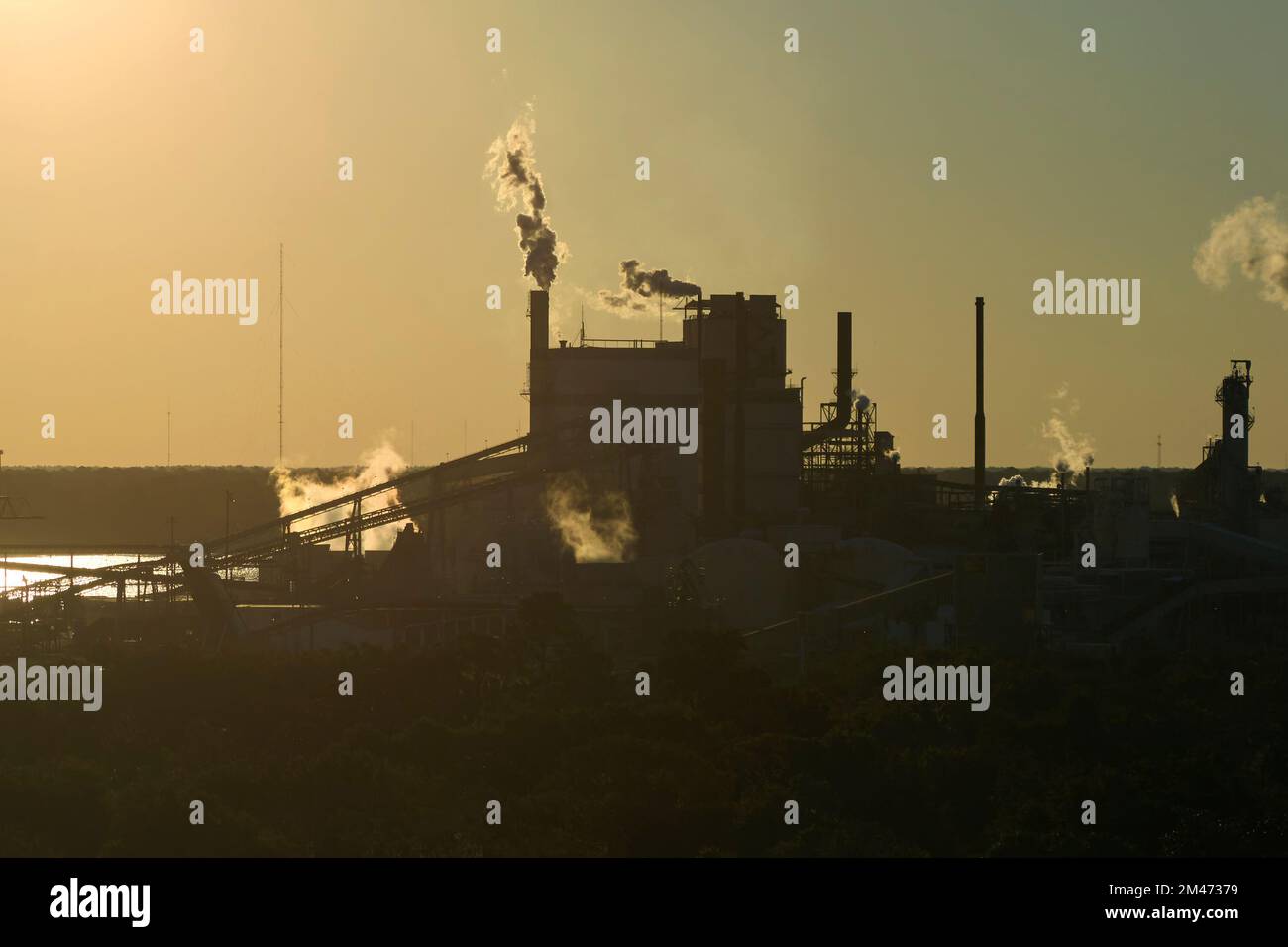 Huge factory with high chimneys polluting atmosphere with carbon ...