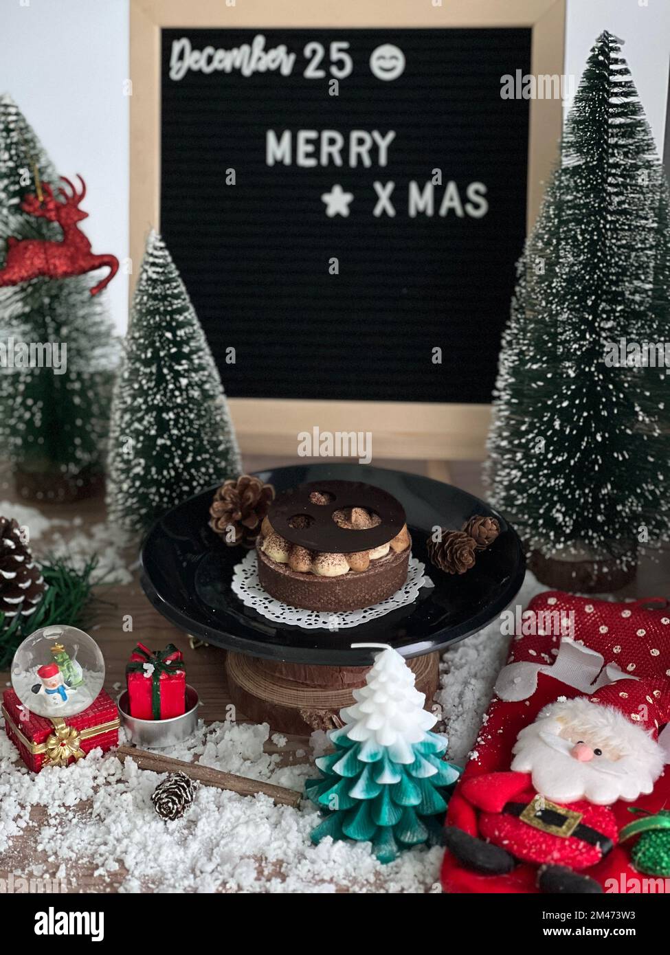 A vertical closeup shot of a Christmas-themed corner with decorative ...